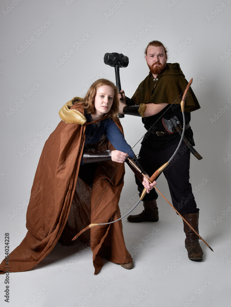 Full length portrait of red haired couple, man and woman wearing ...