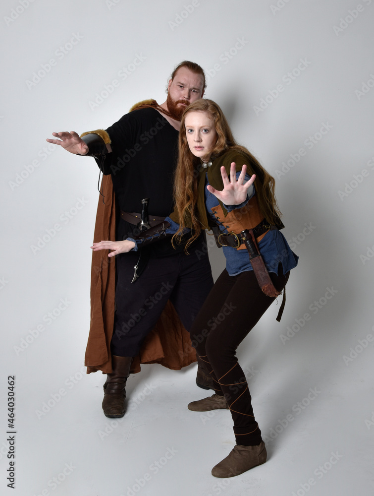 Full length portrait of red haired couple, man and woman wearing ...