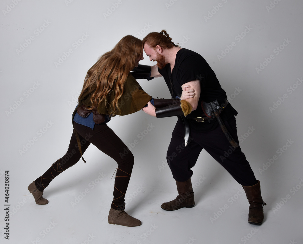 Full length portrait of red haired couple, man and woman wearing ...