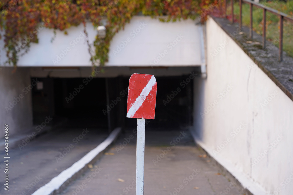Photo of a red with a white stripe on a diagonal rectangular road sign ...