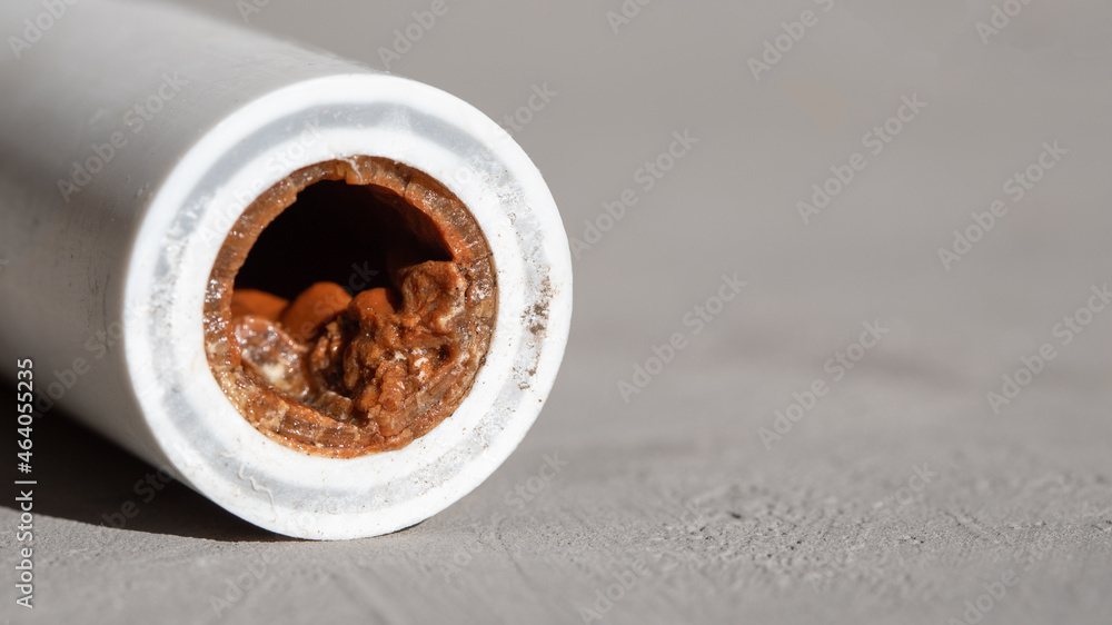 Old broken sludge plumbing polypropylene pipe with red rust and ...