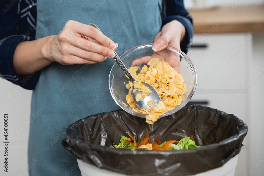 global food pollution concept. Woman throwing a leftover breakfast to ...