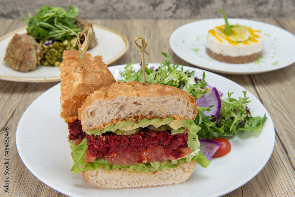 Three courses of food on the table beginning with the veggie burger ...