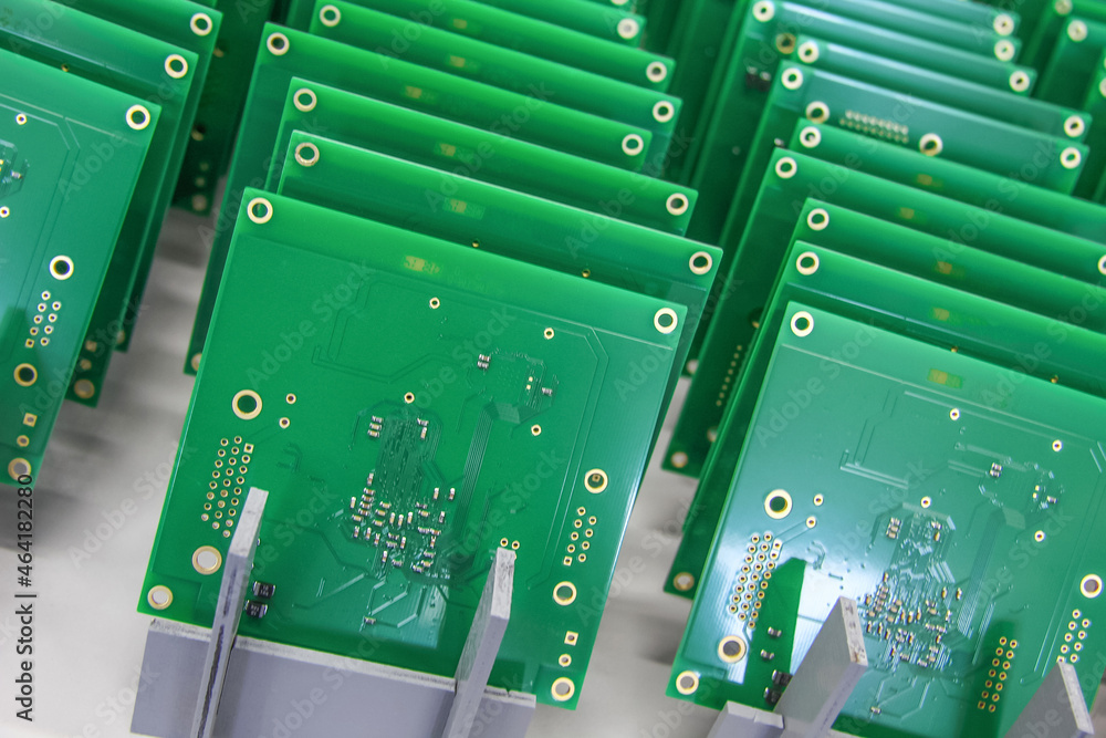 Production and assembly of pcb and chips in a factory. Boards are in a ...