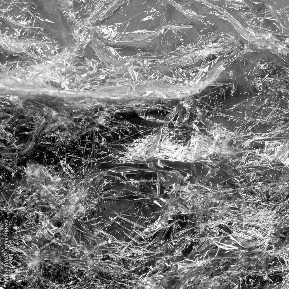 Reflecting light and shadow on creases and folds in scrunched clear ...