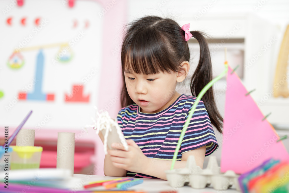 young girl hand making boat craft using egg cartons for homeschooling ...