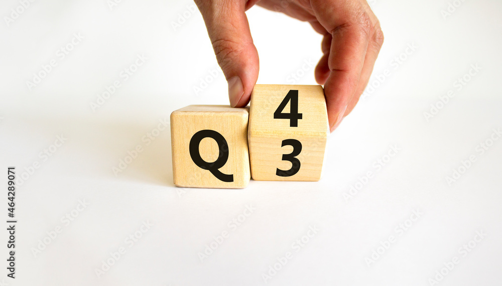 From 3rd to 4th quarter symbol. Businessman turns a wooden cube and ...