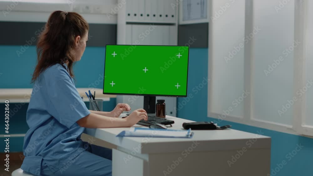 Woman working as nurse with green screen on computer. Healthcare ...