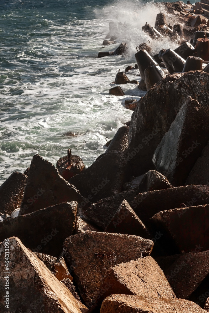 Strengthening the shore from erosion with concrete tetrapods. The ...