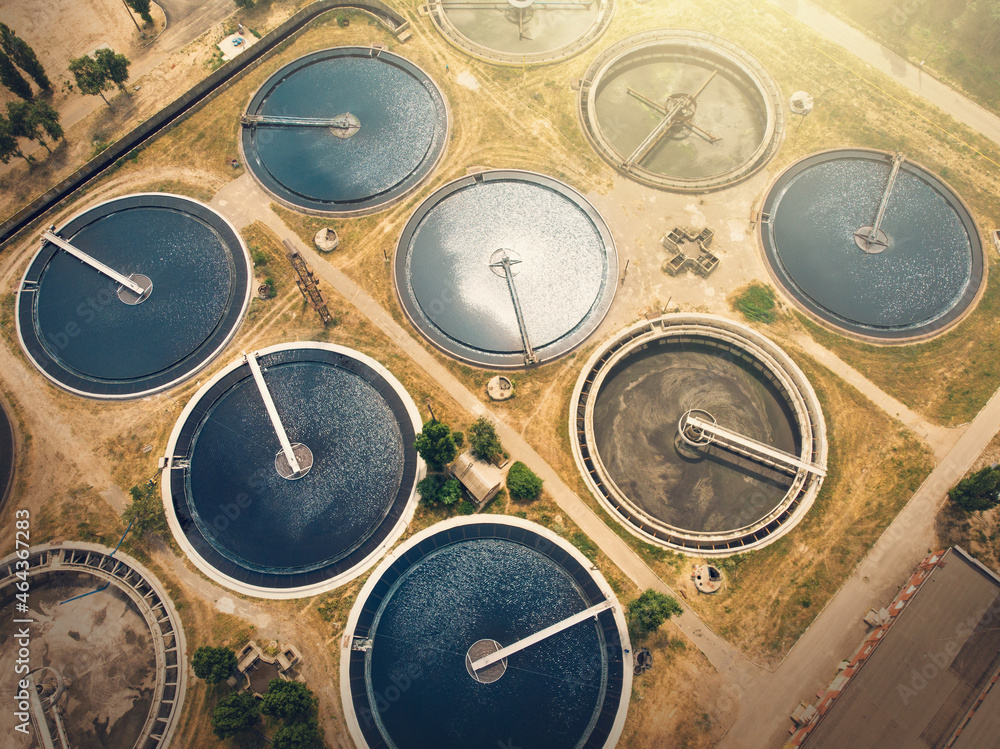 Aerial view of modern industrial sewage treatment plant, round tanks ...