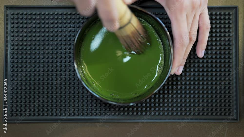 4K Asian woman barista making green tea with fresh milk in the glass ...