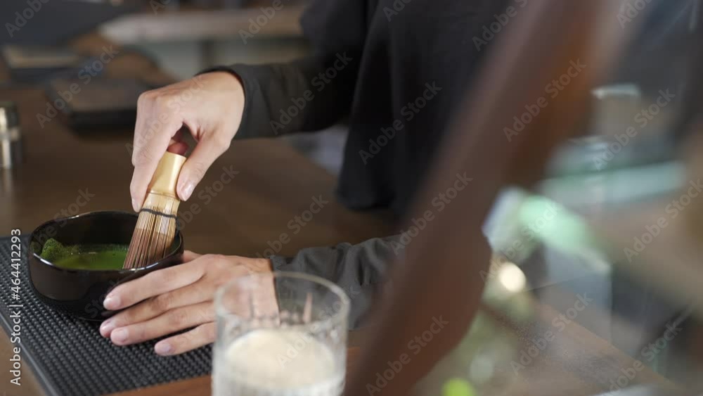 4K Asian woman barista making green tea with fresh milk in the glass ...