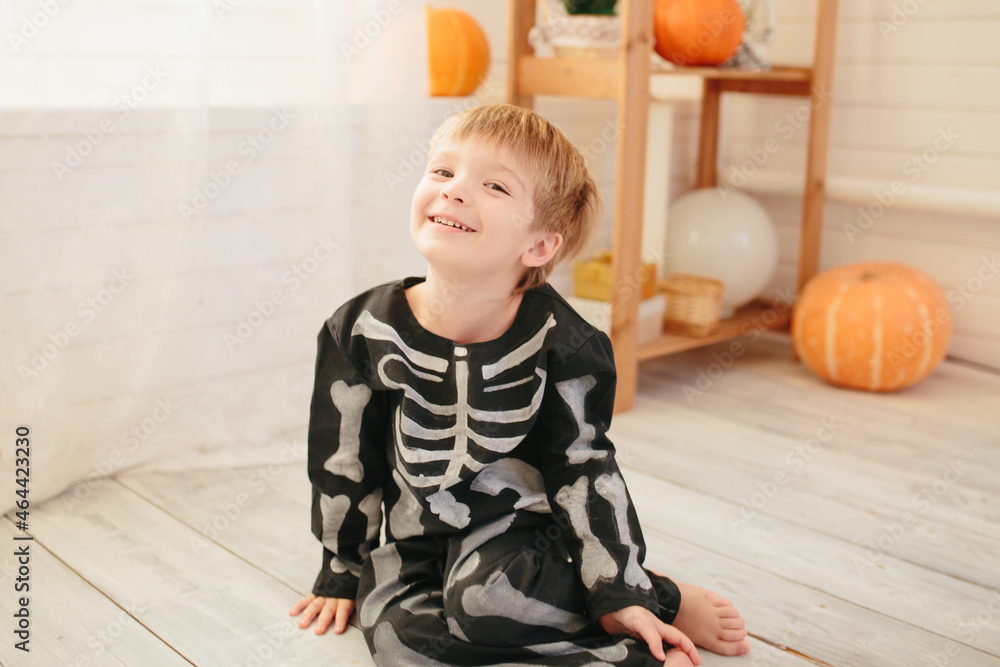 Little cute boy in a skeleton costume is ready for the celebration of ...