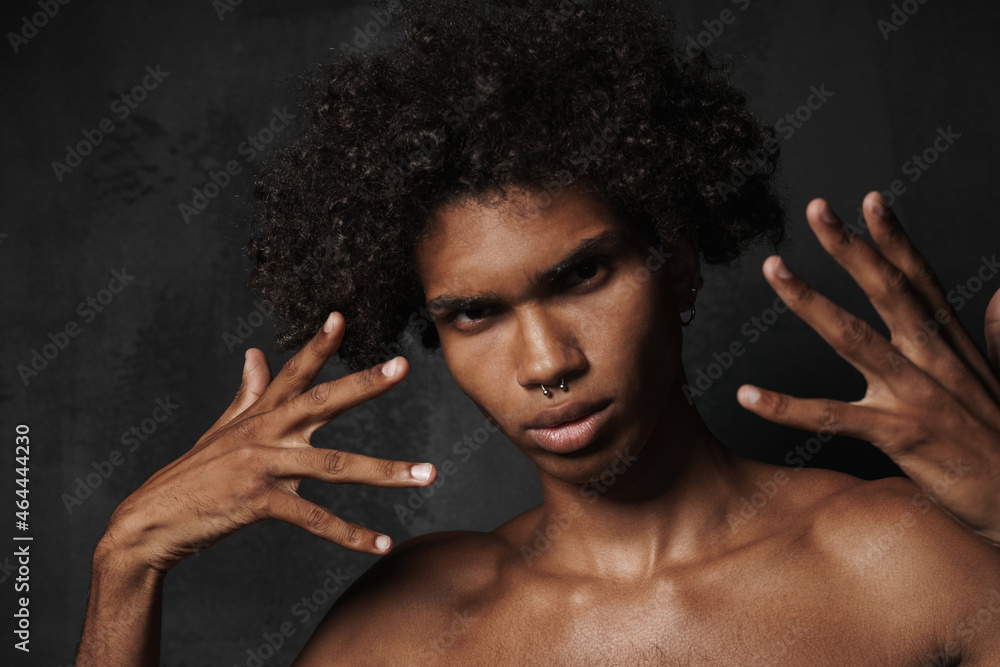 Shirtless black man with piercing posing and gesturing at camera Stock ...