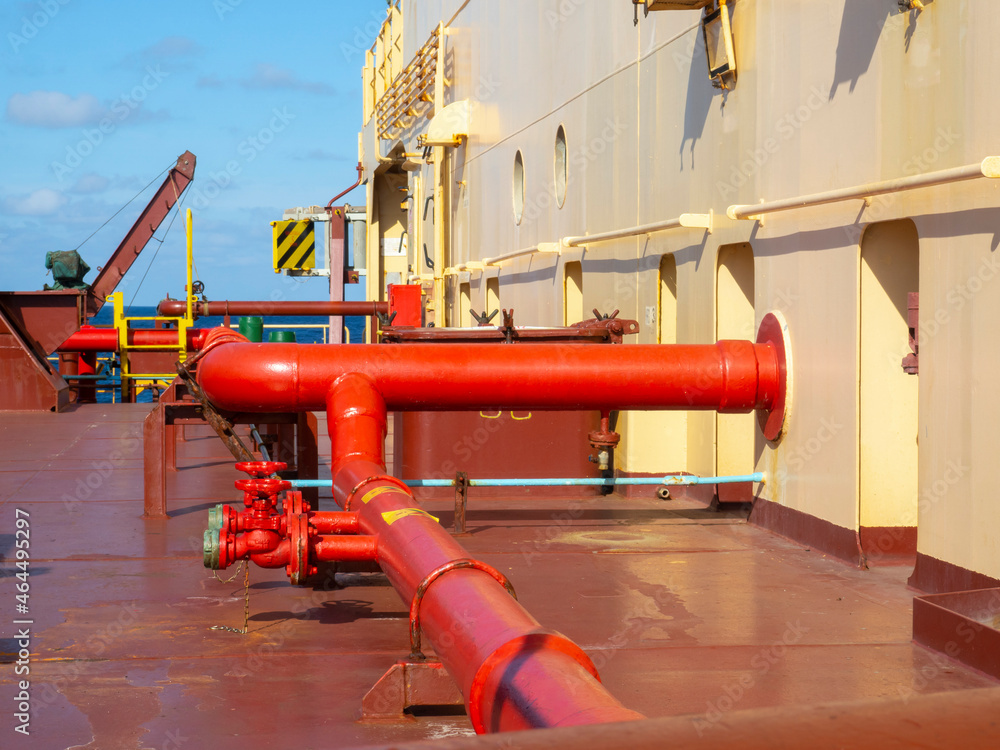 Marine fire extinguishing system with red pipes on a dry cargo ship ...