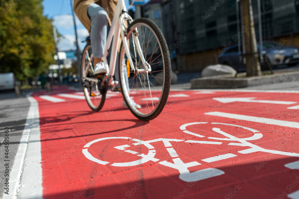traffic, city transport and people concept - woman cycling along red ...