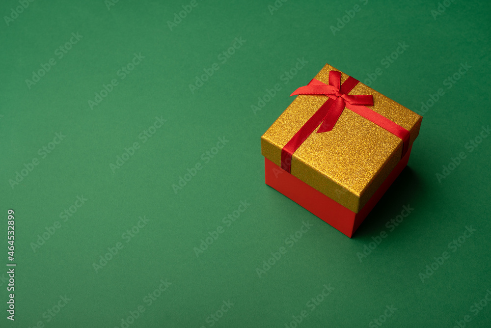 Red and gold gift box on a deep green background. (Flat lay, top view ...