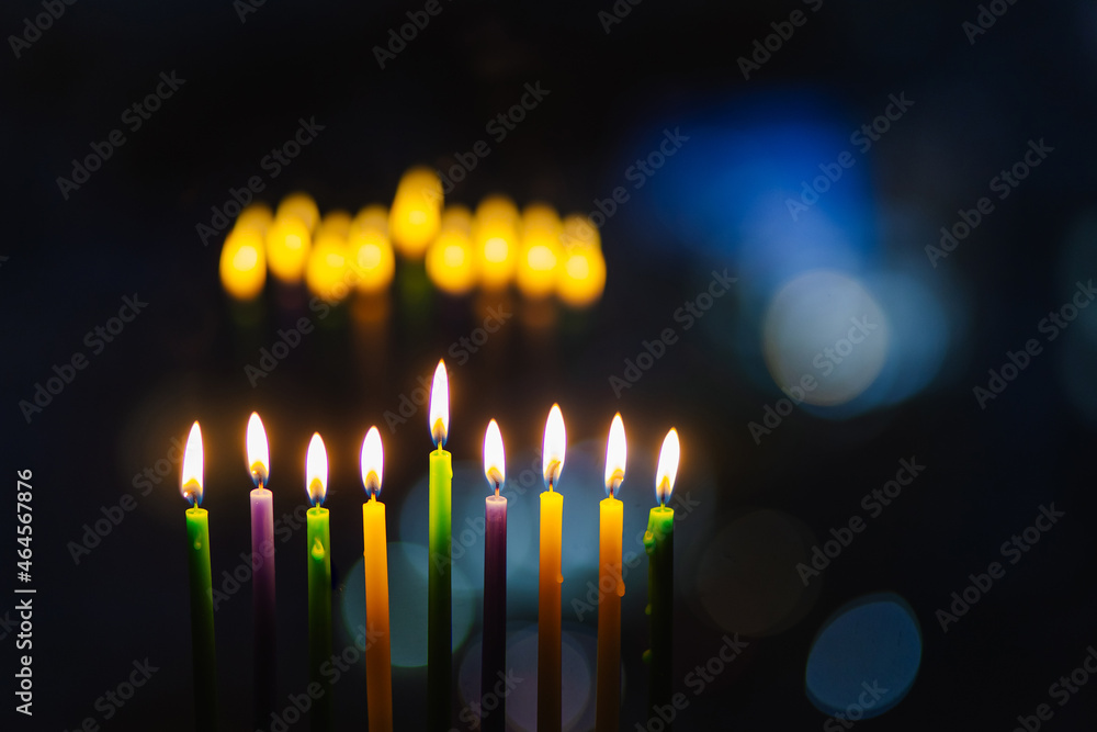 lights the menorah for Hanukkah at sunset sky. Jewish holiday ...