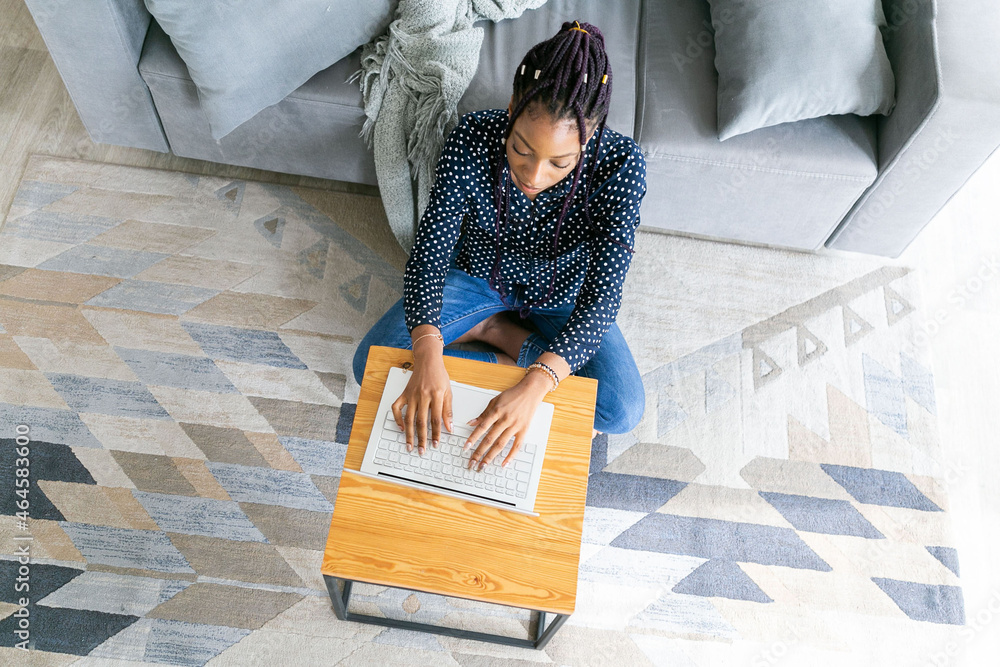 Beautiful young black woman has a zoom call or works in from laptop ...