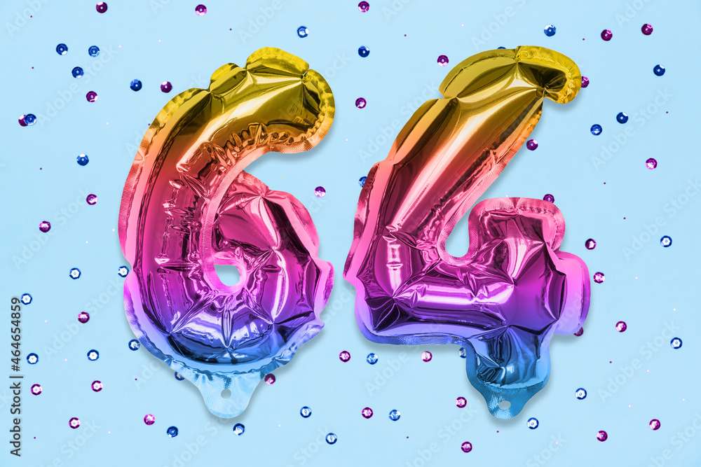 Rainbow foil balloon number, digit sixty four on a blue background with ...