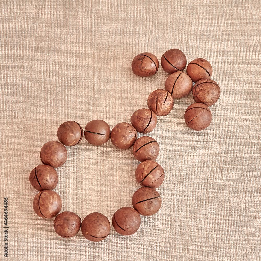 The gender sign indicating the female body is laid out of macadamia ...