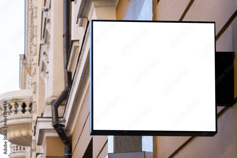 Mock up. Blank white rectangular shape signboard on the wall outdoors ...