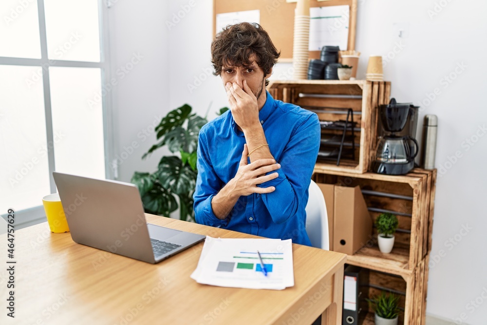 Young hispanic man with beard working at the office using computer ...