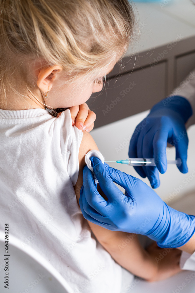 vaccination of children, a little girl at a doctor's appointment, an ...
