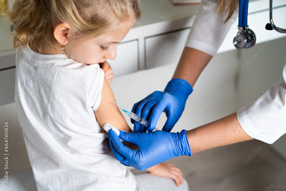 vaccination of children, a little girl at a doctor's appointment, an ...