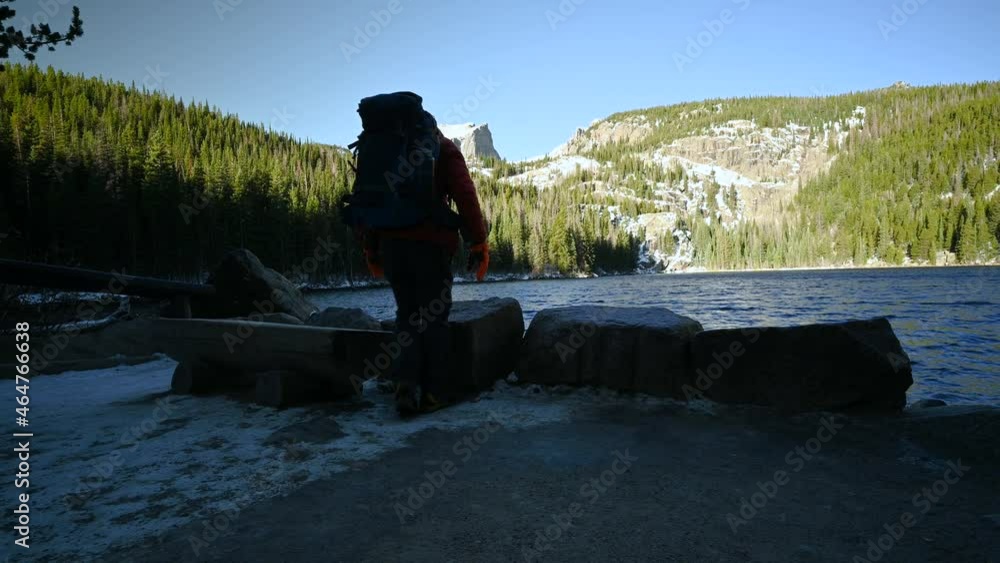 Hiker relaxes on a bench at one of the most popular alpine lakes in ...
