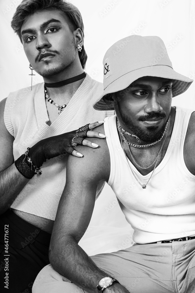 Malaysian Indian men posed in front of a cloth backdrop in a studio ...