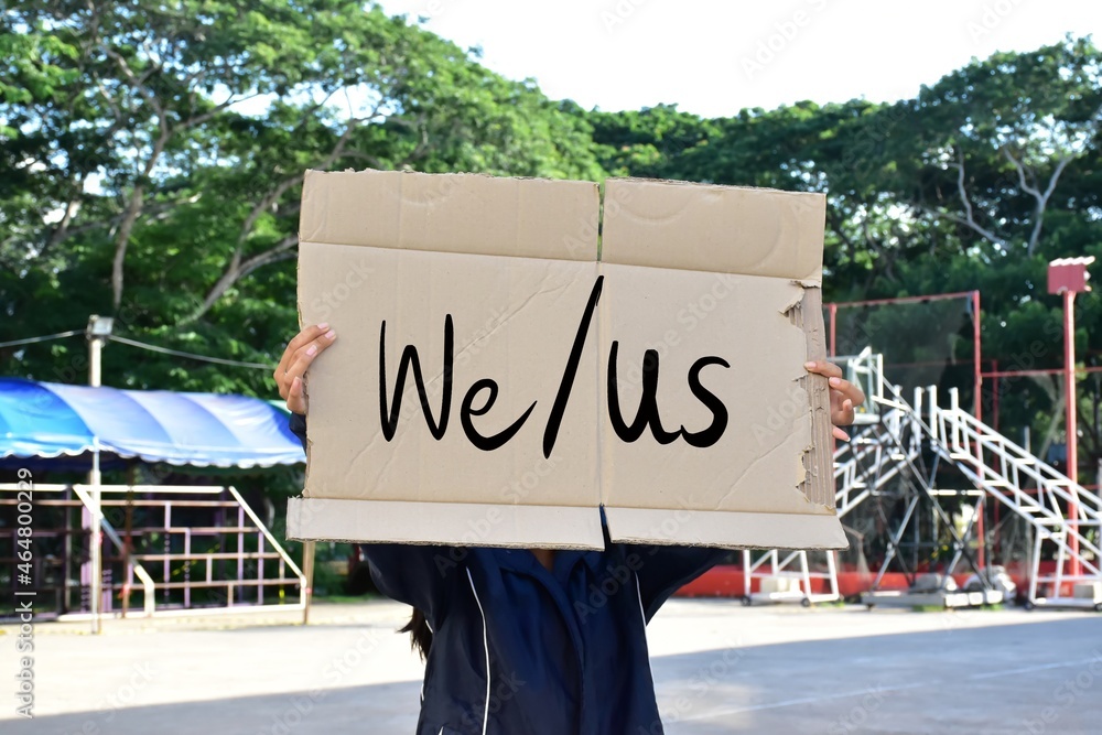 Subject and object pronouns 'We and us' on paper holding in hands of ...