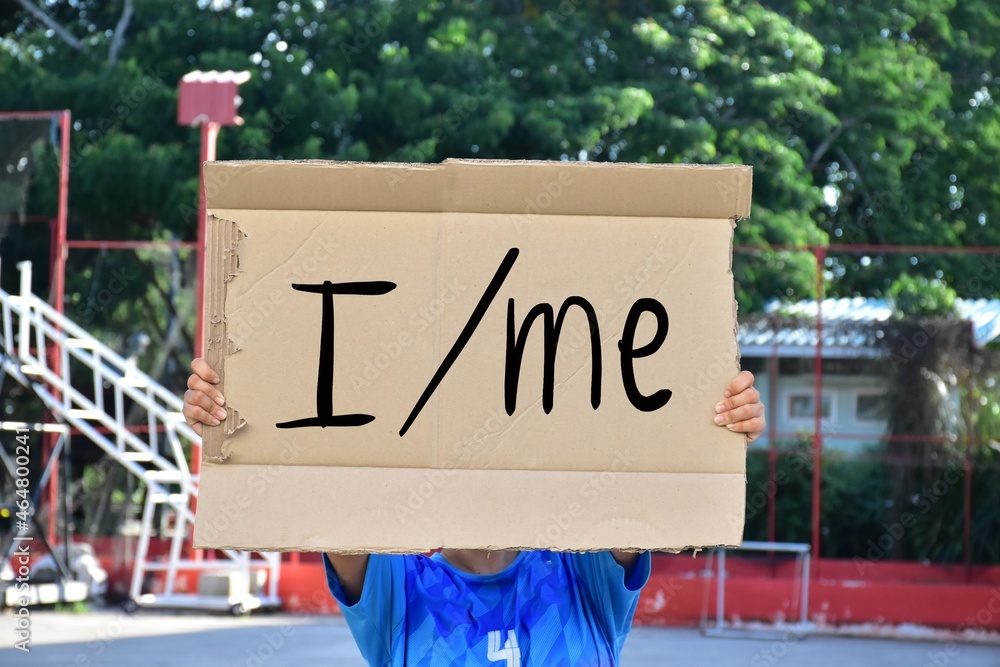 Subject and object pronouns 'I and me' on paper holding in hands of ...