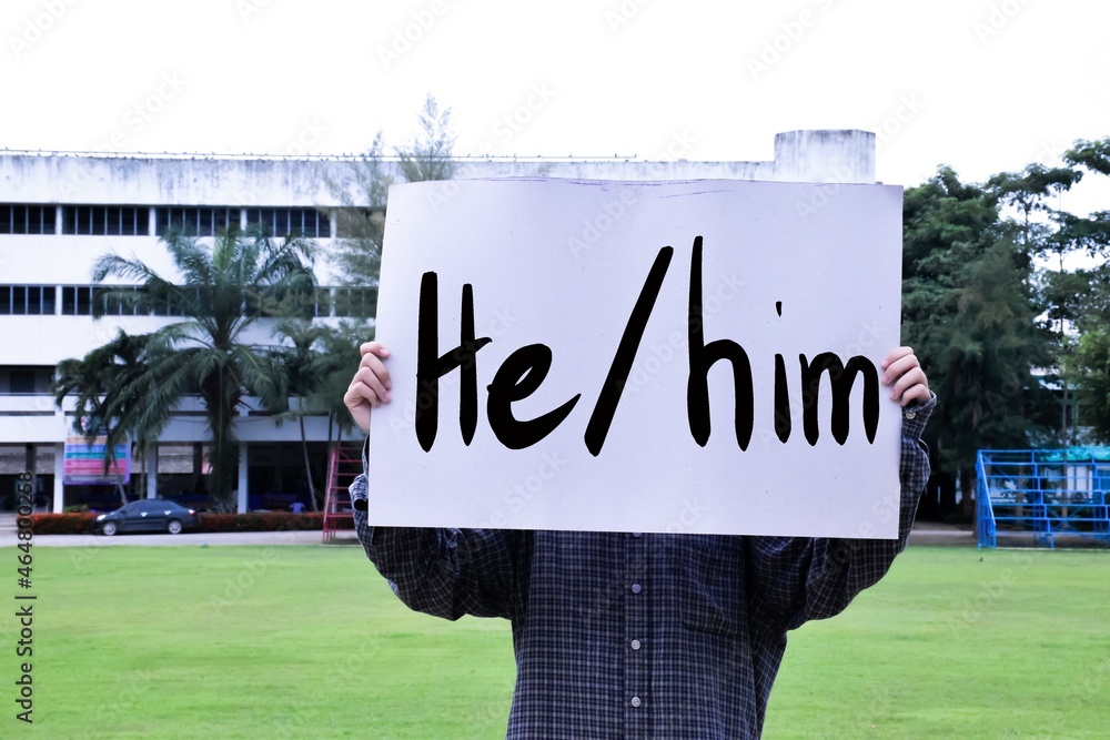Subject and object pronouns 'He and him' on paper holding in hands of ...