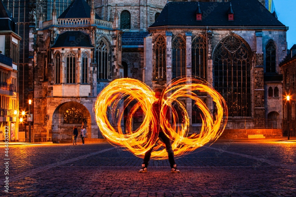 fire spinner creating shapes in front of cathedral Stock Photo | Adobe ...