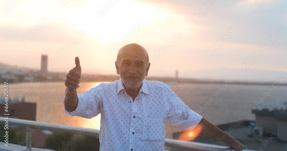 Happy funny old man is saying yes with his gestures. Elder successful ...