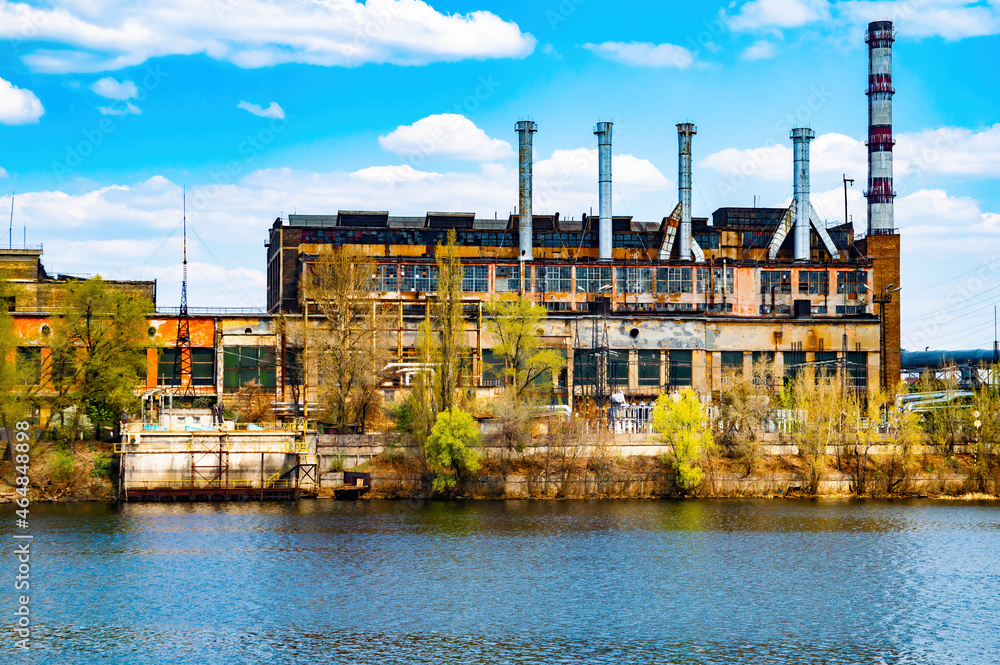 Industrial plant with chimneys on the river bank. Industrial building ...
