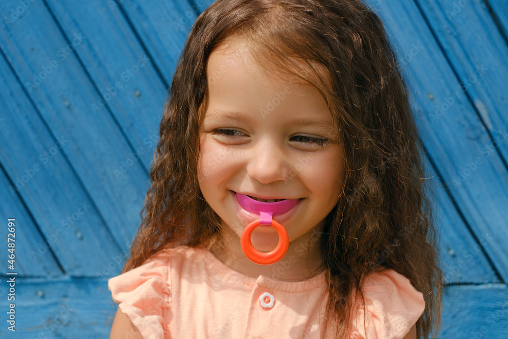 Laughing baby with mouthguard in mouth for bite alignment. Crooked ...
