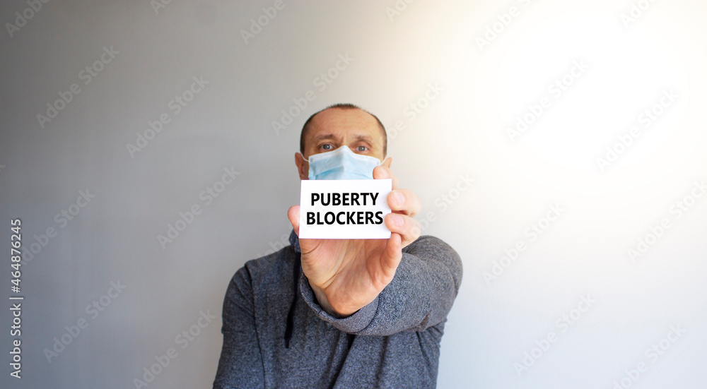 Puberty blockers symbol. White card with words 'Puberty blockers'. A ...