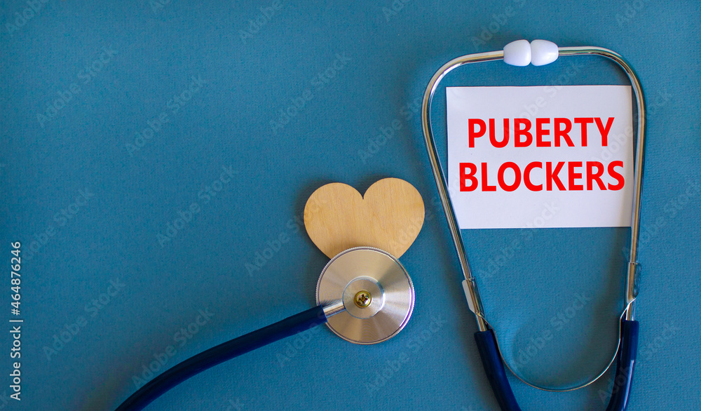 Medical and puberty blockers symbol. White card with words 'puberty ...