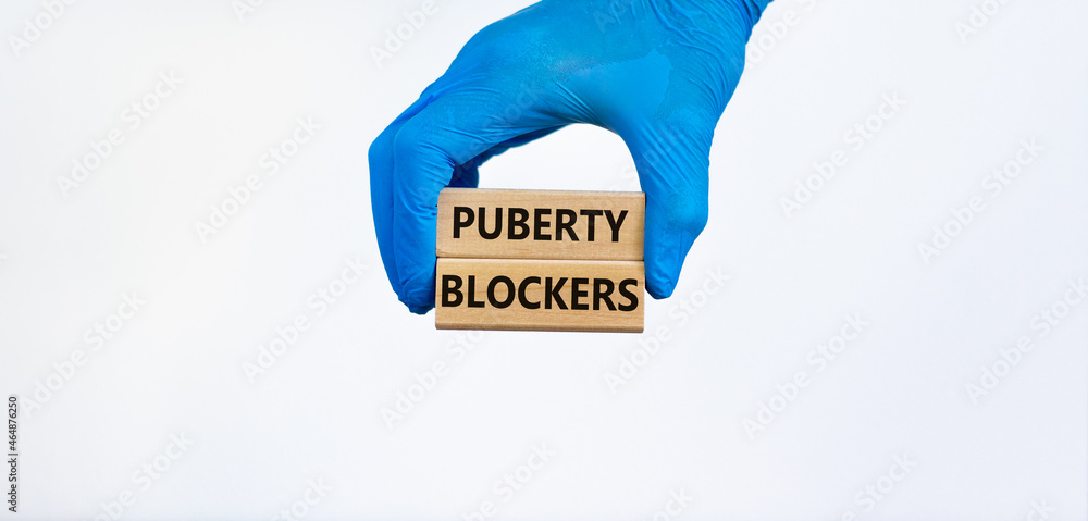 Medical and puberty blockers symbol. Words 'puberty blockers' on wooden ...