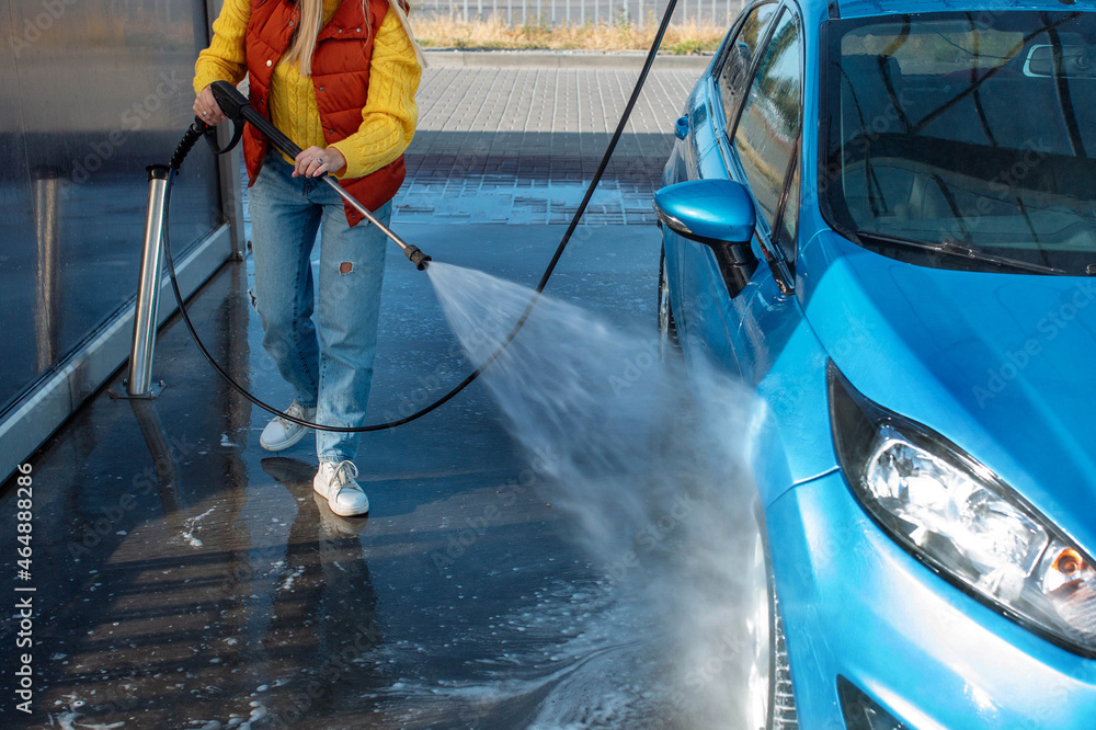 portrait young, smiling, happy, attractive woman washing automobile at ...