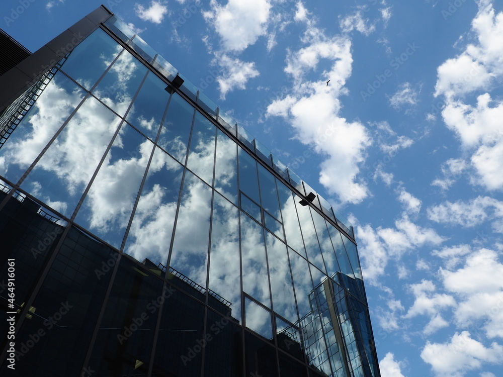 The sky and glass facade of the building. Reflection of the blue sky ...