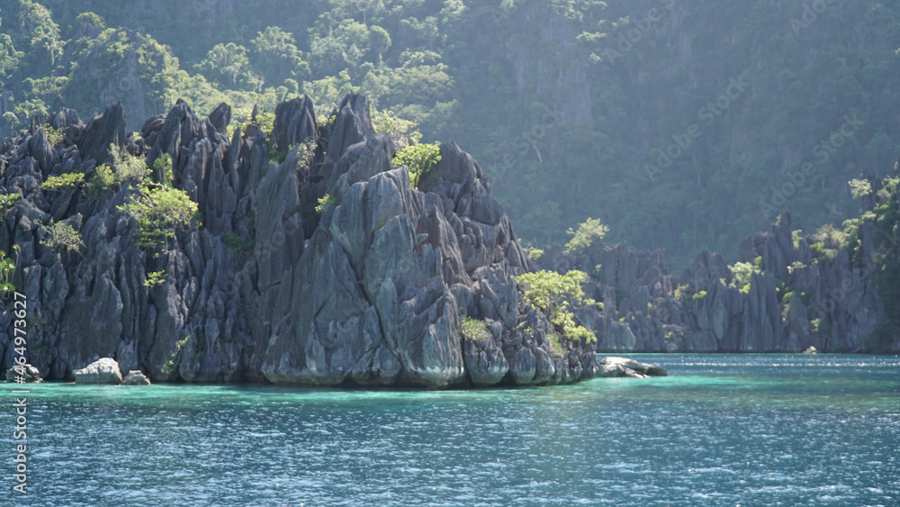 Ocean and jagged rock landscapes with turquoise water at Coron Island ...