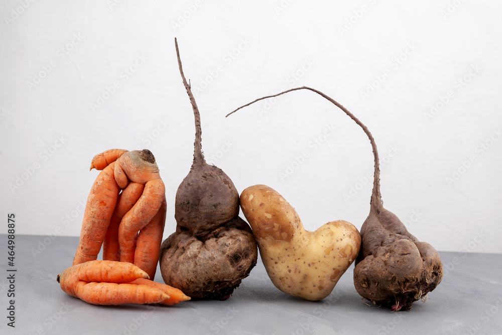 Different Ugly vegetables, side view, close-up. Organic food waste ...