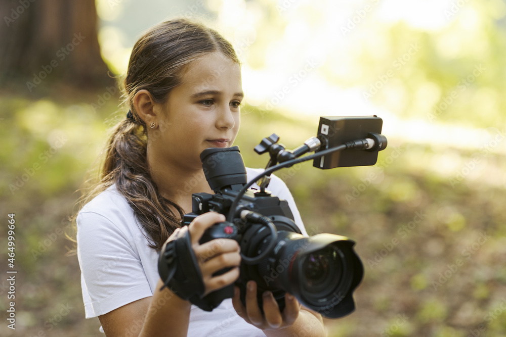 Cute girl shooting a video with a professional video camera Stock Photo ...