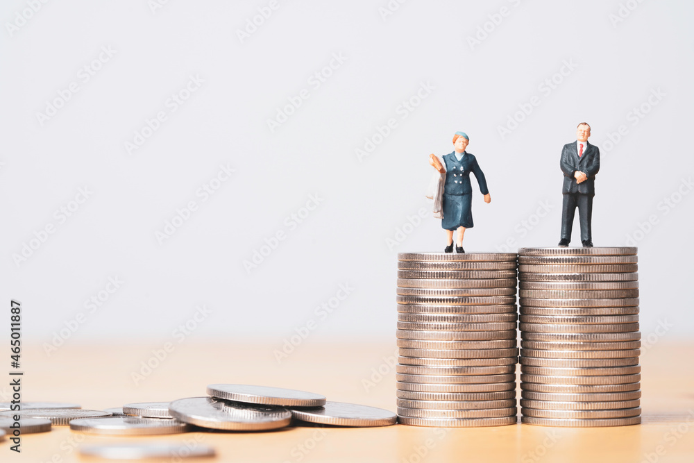 Miniature figure of businessman standing on equal coins stacking of ...