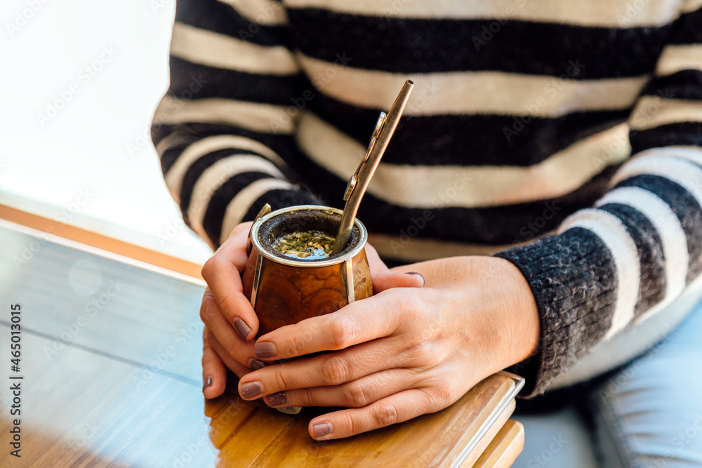 Woman with a Mate in her hands. Ready to drink. Yerba Mate of Argentina ...