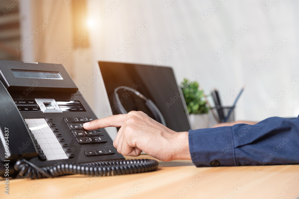 Call center staff man hand point to press the button number on the ...