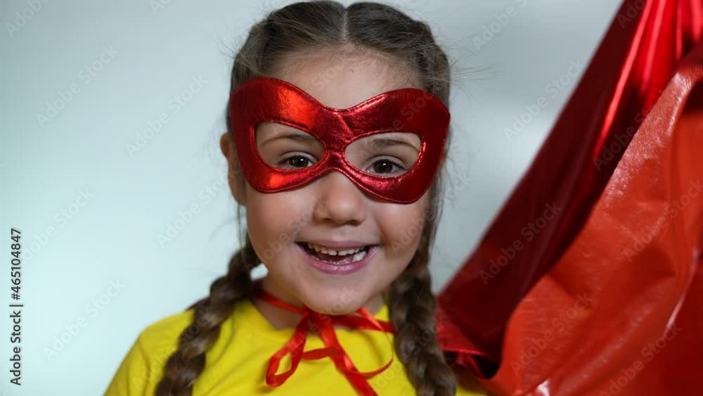 Girl in superhero mask. Child in hero costume. Happy child is winner ...